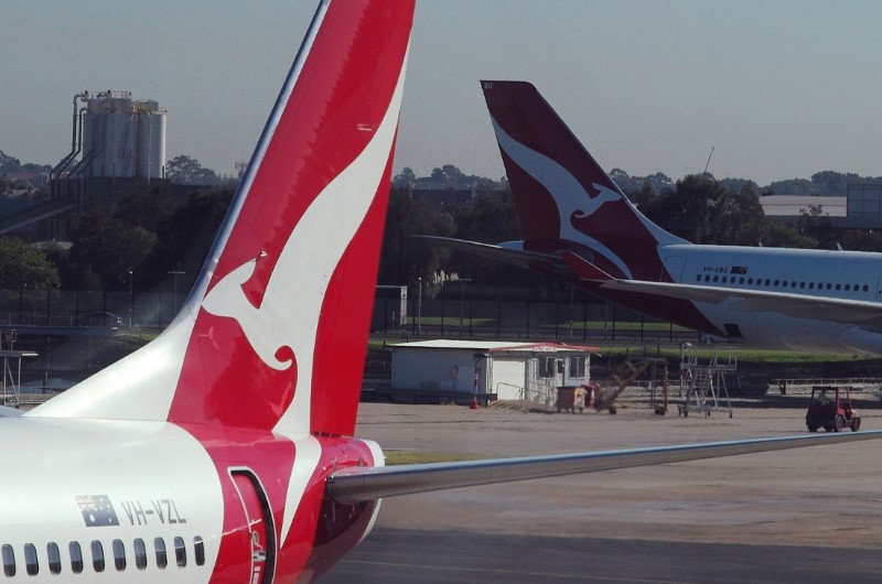 Passengers evacuate Qantas plane via emergency slides at Sydney airport ...